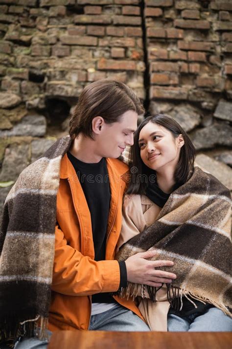 Smiling Interracial Couple In Blanket Looking Stock Image Image Of
