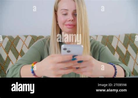 Beautiful Blonde White Woman With One Eye And Scars Using Mobile Phone