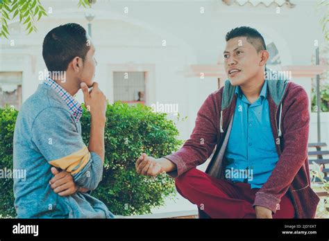 Two Young People Having A Conversation Outdoors Two Friends Having A