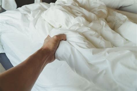 Premium Photo The Mans Hand Pulled The White Sheets Hand Mauled The