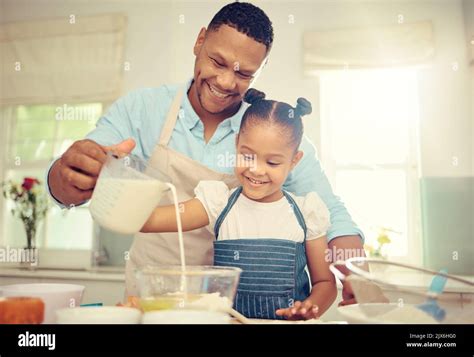 Father Teaching Girl To Bake And Make Dough In A Messy Kitchen Caring