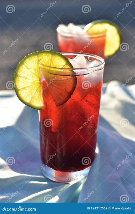 Cold Iced Tea In Glasses And Pitcher With Lime Slices In Hot Desert