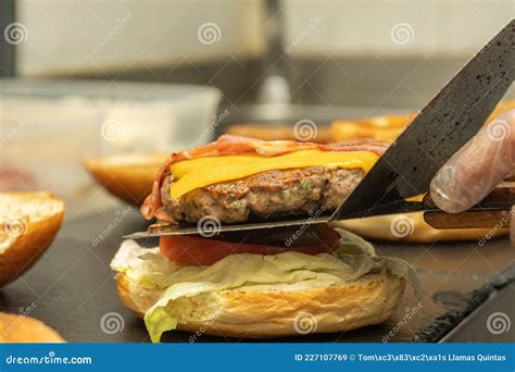 Chef S Hands Assembling Burgers With Cheddar Cheese And Bacon Over Tomato Stock Image Image Of