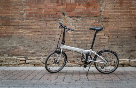 Lightweight Folding Bike In An Alley Against Brick Wall Stock Image