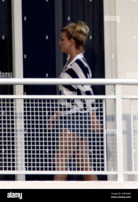 Britney Spears Wearing Daisy Dukes And A Striped Top Relaxes While