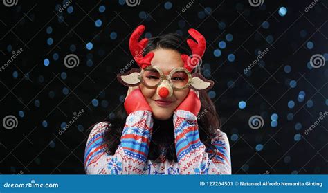 Asian Girl Wearing Christmas Sweater And Christmas Reindeer Glasses Red