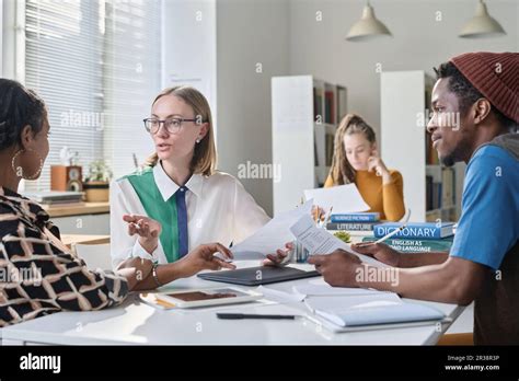 Young Teacher Teaching Foreign Language To Students While They Sitting