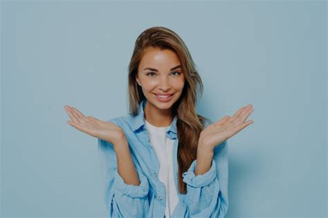 Premium Photo Optimistic Lovely Young Female Spreads Hands Smiles Happily