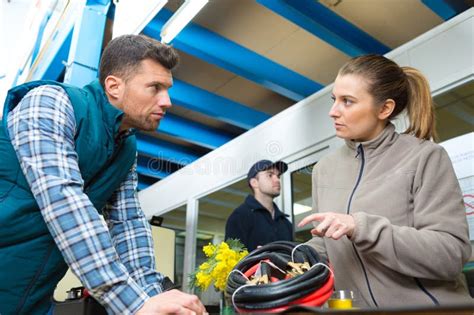 female engineer shows problem to colleague stock image image of pipe