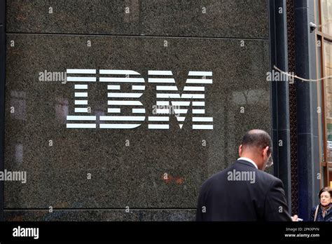 A Businessman Walks Past The Ibm Building At 590 Madison Ave New York