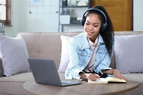 Premium Photo Smiling Asian Young Female Using Headphones Looking At