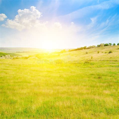 Hilly Green Field And Windmill On Blue Sky Background Stock Image