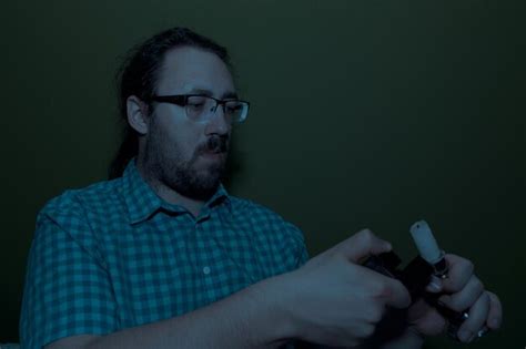 Premium Photo Man In The Dark Trying To Light A Candle With A Lighter