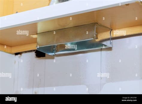 During Installation Process Worker Places For Kitchen Hood Onto Kitchen