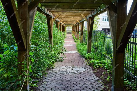 Premium Photo Wooden Trellis Walkway Through Garden With Black Fence