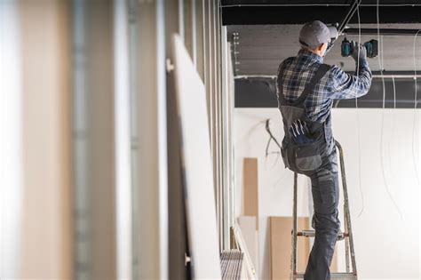 Premium Photo Electrician Installing Ceiling Lighting Elements