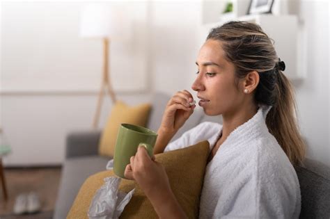 Premium Photo Young Lady Very Ill Taking A Flu Pill While Holding Her