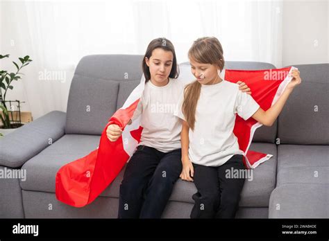 Happy Canada Day Celebration Two Girls With Big Canada Flag In Their