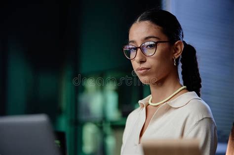 portrait middle eastern female programmer glasses using computer