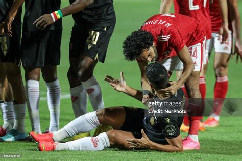 Hussein El Shahat Of Al Ahly Talk To Jalal Daoudi Of Wydad Ac During