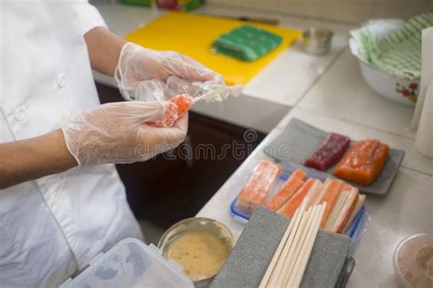 Hands In Gloves Of Asian Professional Chef Preparing Delicious And