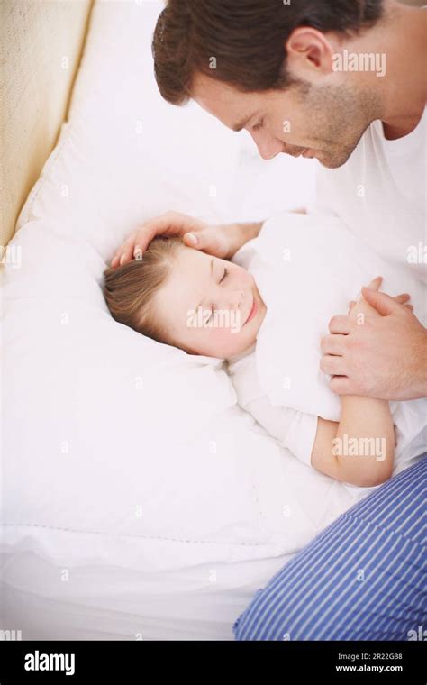 Wishing Her The Sweetest Dreams A Dad Sitting By His Daughter While