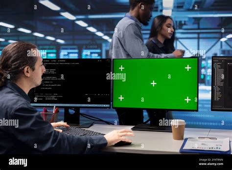 Programmer In Data Center Using Green Screen Computer To Check For