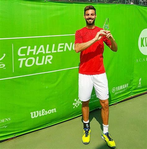 Download Marcel Granollers Holding Trophy Wallpaper | Wallpapers.com