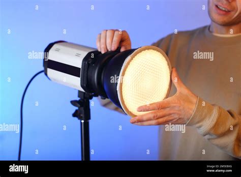 A Flash With A Modifier On With A Diffuser With A Person In The