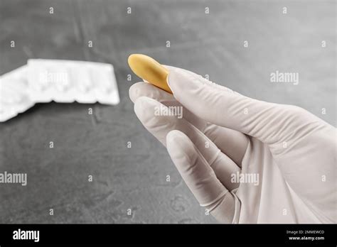 Woman Holding Suppository At Grey Table Closeup Hemorrhoid Treatment Stock Photo Alamy
