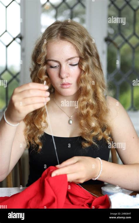 Teenage Girl Hand Sewing With Needle And Thread Textiles Craft Skills