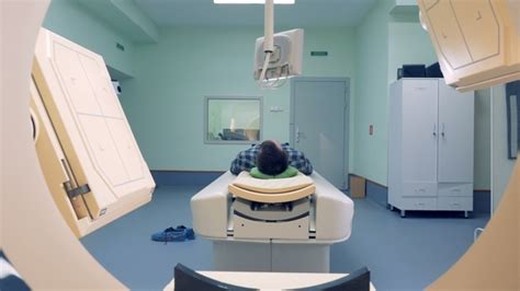 Start Of A Tomographic Procedure Held In An Equipped Medical Room