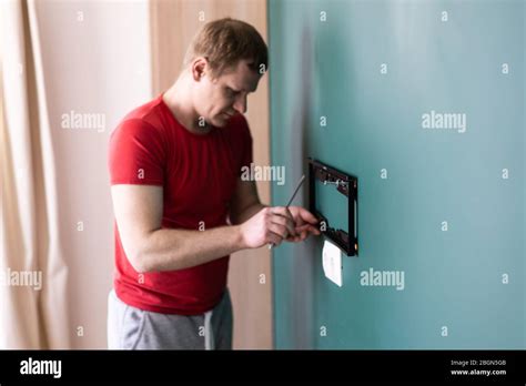 Repair And Decoration Husband For An Hour Service A Man Attaches A