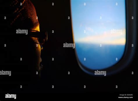 An Airline Passenger Looks Out Of The Window Of A Boeing 787 Dreamliner
