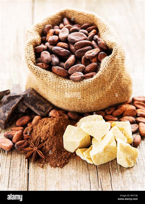 Natural Cocoa Beans Powder Chocolate And Butter On A Old Wooden