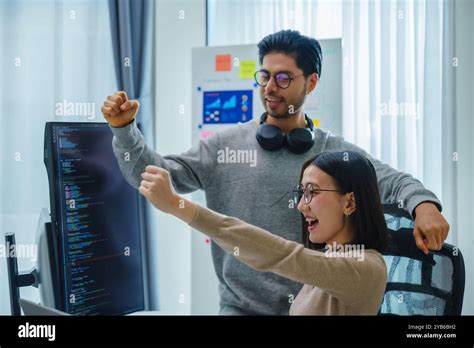 Asian And Indian Developer Team Clapping Hand For Project Success With Software Computer At