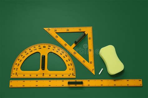 Protractor Triangle Ruler And Sponge On Green Chalkboard Flat Lay