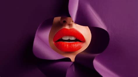Premium Photo View Of Bright Lips Through Hole In Violet Paper Background