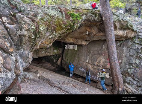 Visitors Explore The Entrance Of Robbers Cave At Robbers Cave State