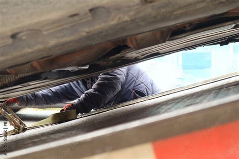 Welder Working A Colombian Man Operates A Crane While Working Underneath It In The Process Of