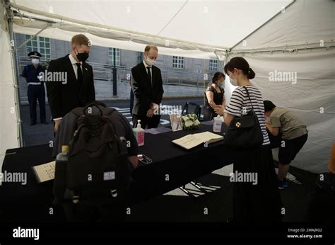 People Sign The Condolence Book Set Up For The Passing Of Queen