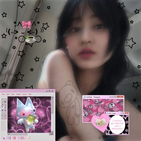 A Girl With Black Hair Is Looking At The Camera And Has Tattoos On Her Arm