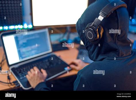 Hacker In The Hood Sitting At Laptop Back View Information Hacking Internet Spy Male