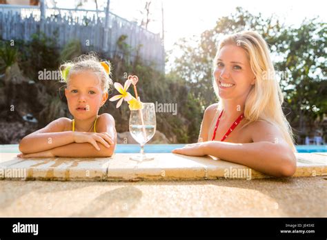 Outdoor Portrait Of Beautiful Blonde Mother And Her Cute Daughter
