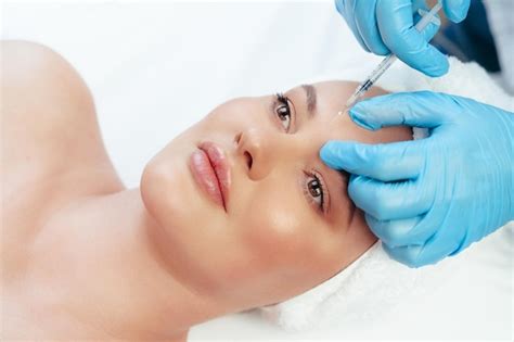 Premium Photo Portrait Of A Beautiful Woman Having An Injection Of Botox In Her Face