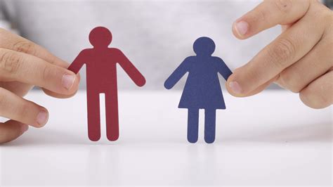 A Man Holding Paper Cutouts Of A Man And Woman Separation 27384316