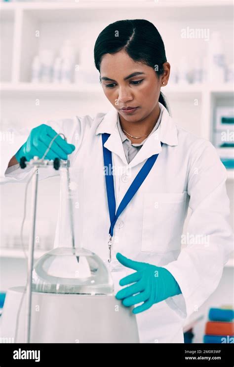 Conducting Experiments To Test Her Theories An Attractive Young Female Scientist Working With A