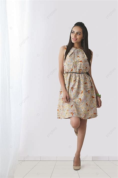 Full Length Of Beautiful Young Woman In Sundress Leaning Against Wall