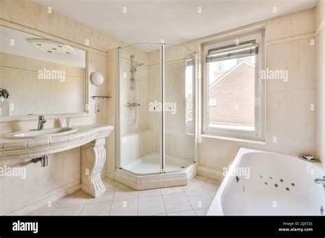 Interior Of Vintage White Tiled Bathroom With Shower And Sink With