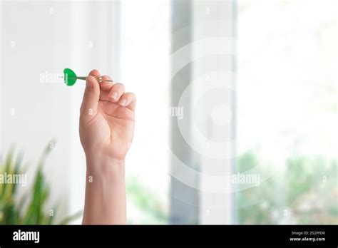 Hand Holding A Dart Aiming Through An Imagined Target Symbolizing